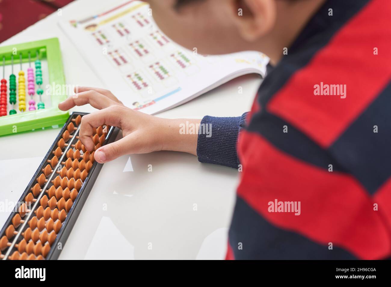 Schoolboy do mental math. Mental mathematics. 8 years old multiracial ...
