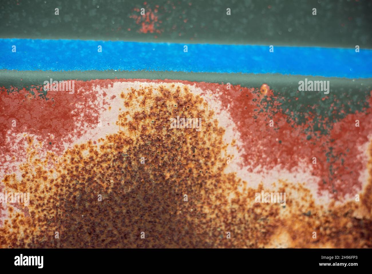 Painted iron surface with deteriorating surface showing rust coming ...