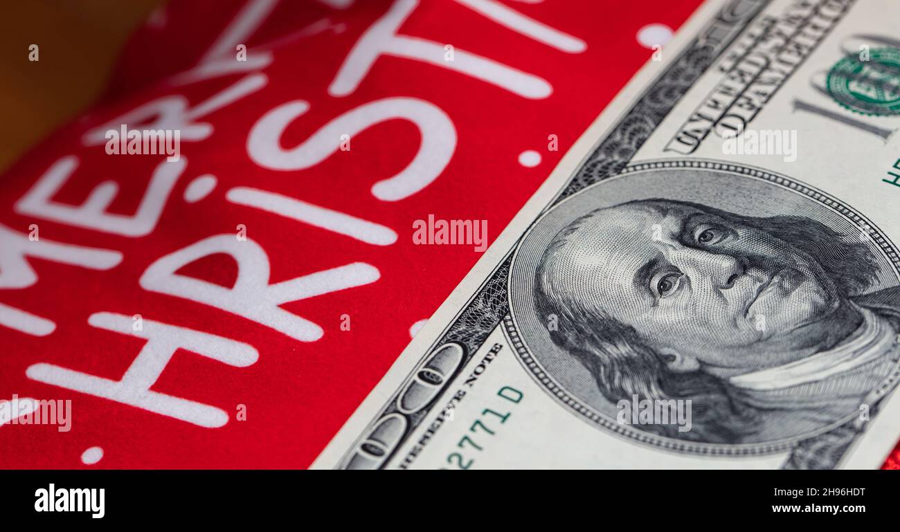 US 100 dollar banknote and Merry Christmas text on red background for ...