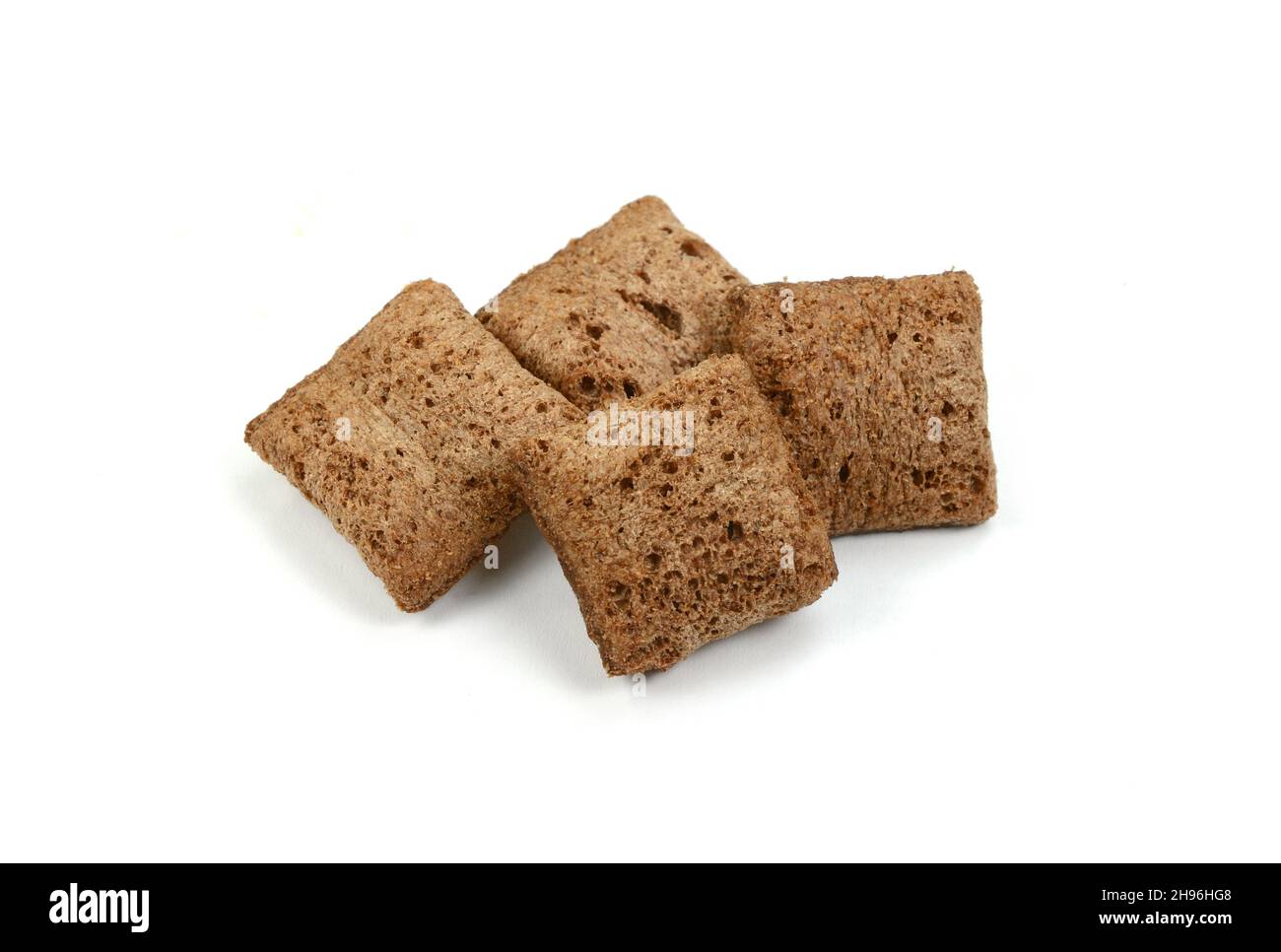 Heap of chocolate pillow cereals isolated on white background. Nougat ...
