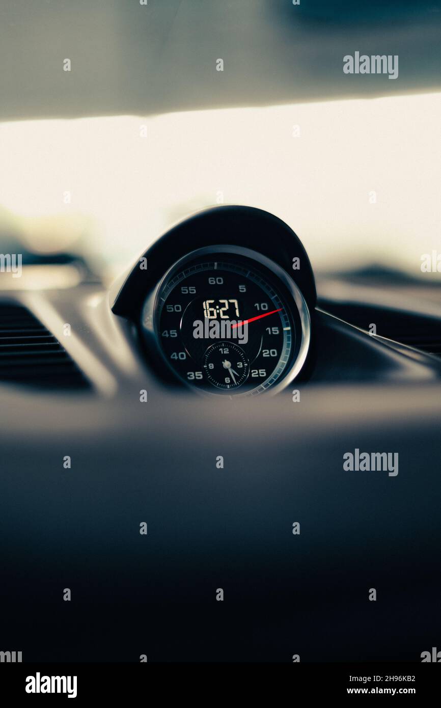 Vertical shot of a lap timer on a sports car with a blurry background ...