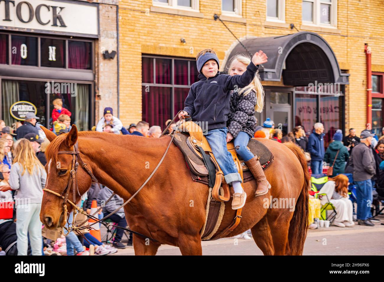 Oklahoma, DEC 4, 2021 - Boy and girl riding a horse in Cowboy Christmas ...