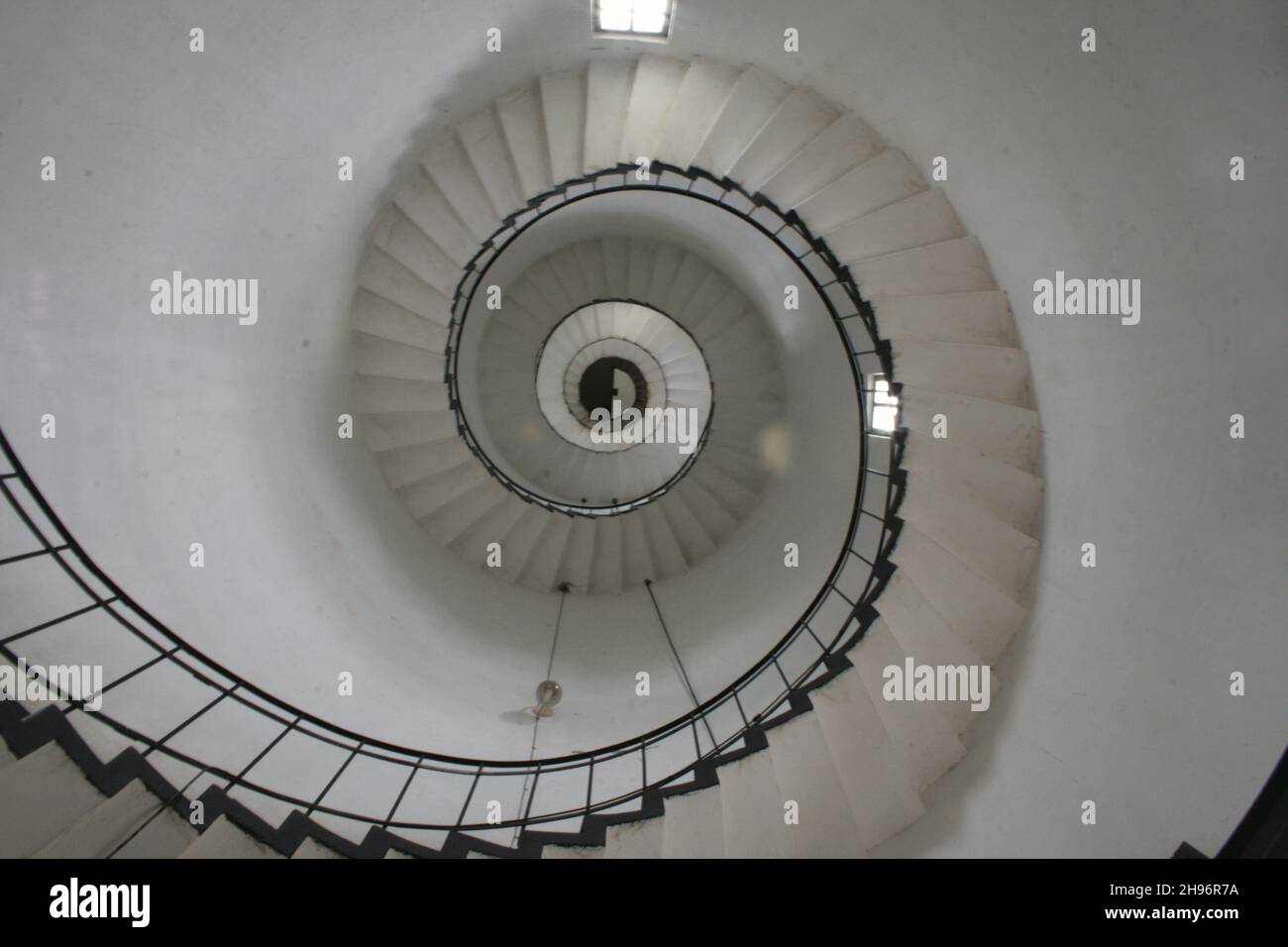 Top view of a winding staircase in a white building Stock Photo - Alamy