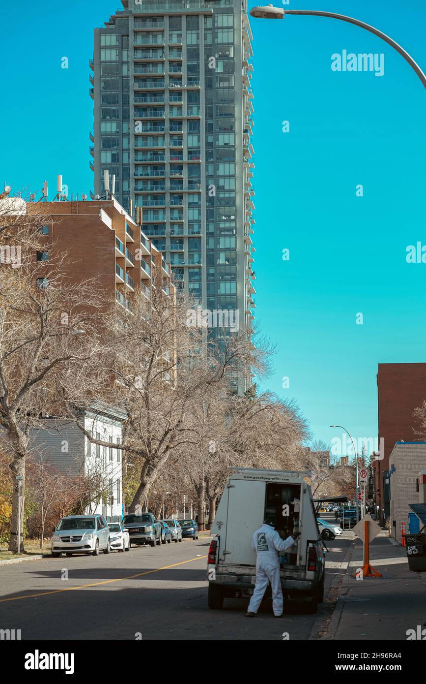CALGARY, CANADA - Oct 26, 2021: A worker in a white uniform getting ...