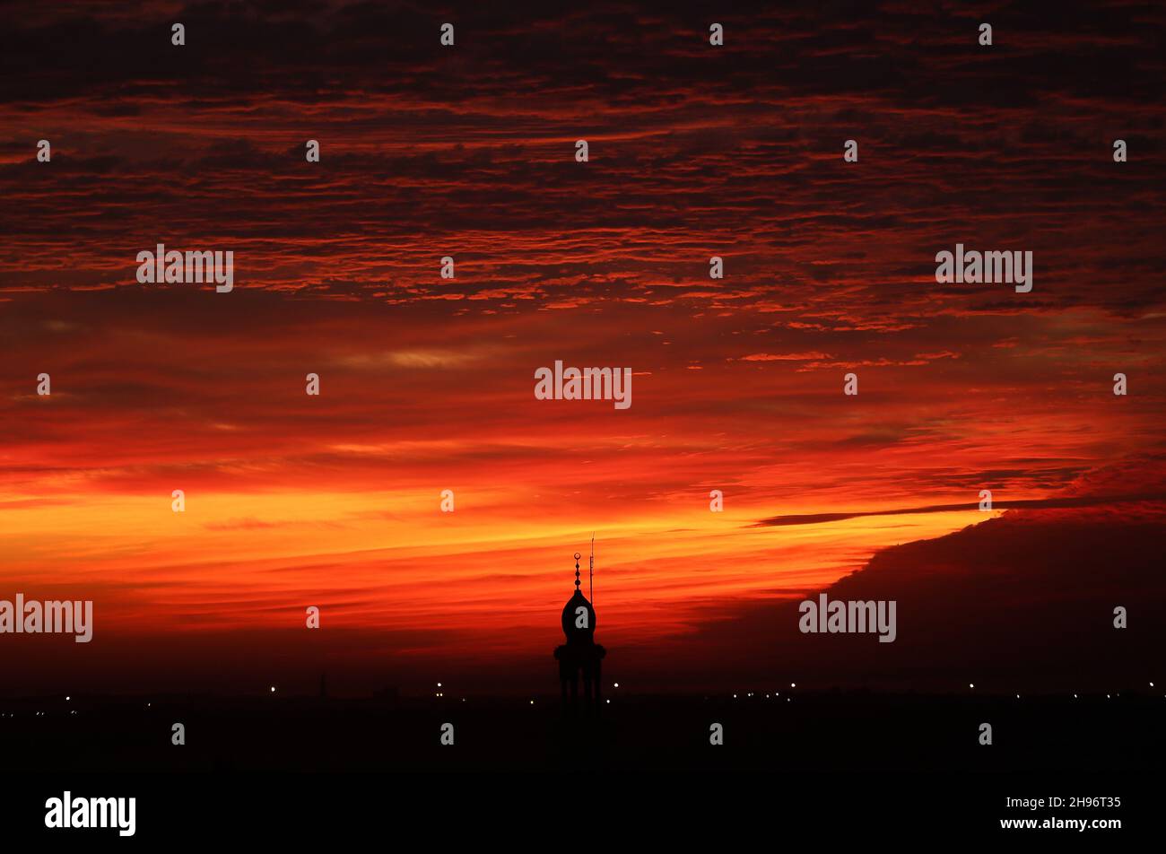 A view of the minaret of the Great Mosque during sunset in Khan Yunis ...