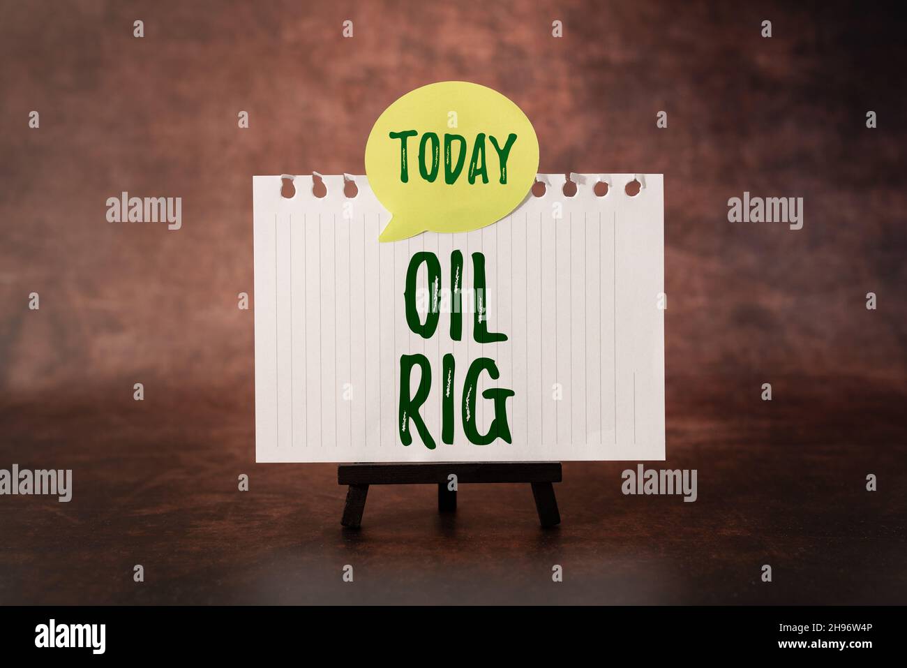 Sign displaying Oil Rig. Word Written on large structure with equipment ...