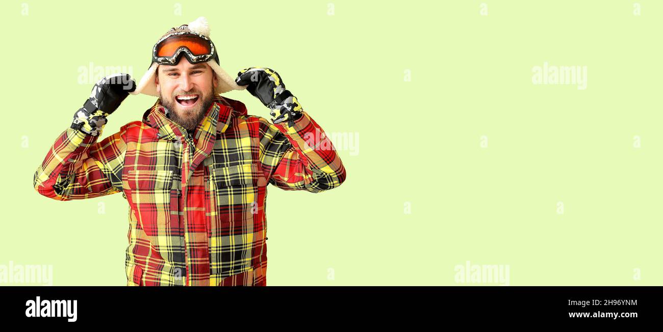 Happy male snowboarder on color background with space for text Stock ...