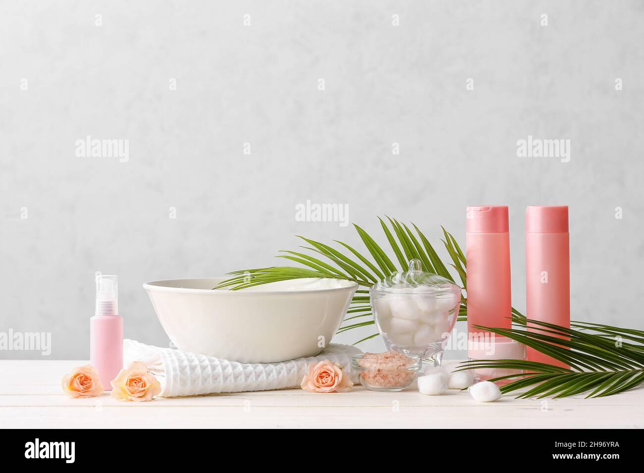 Spa set with bowl of water on light background Stock Photo - Alamy