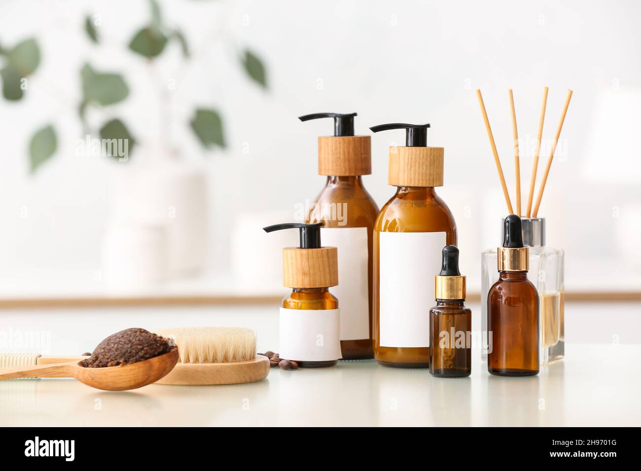 Spa set with bottles of cosmetics on light background Stock Photo - Alamy