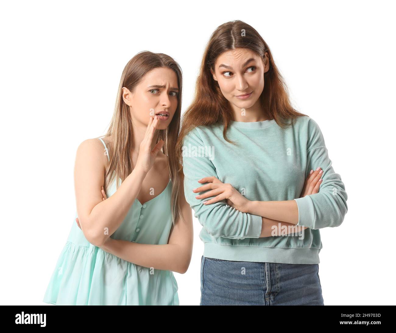 Young gossiping women on white background Stock Photo - Alamy