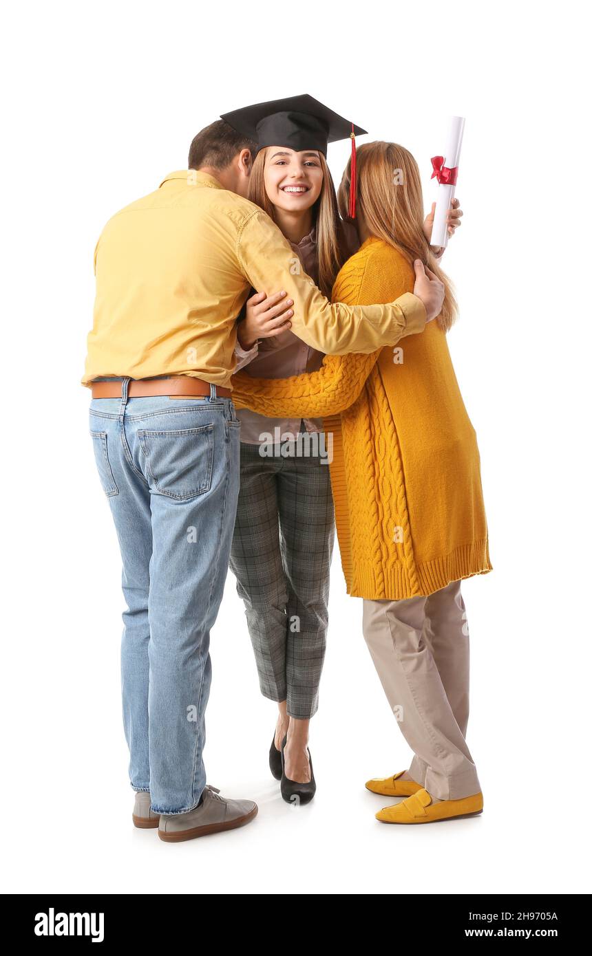 Happy female graduation student with her parents on white background ...