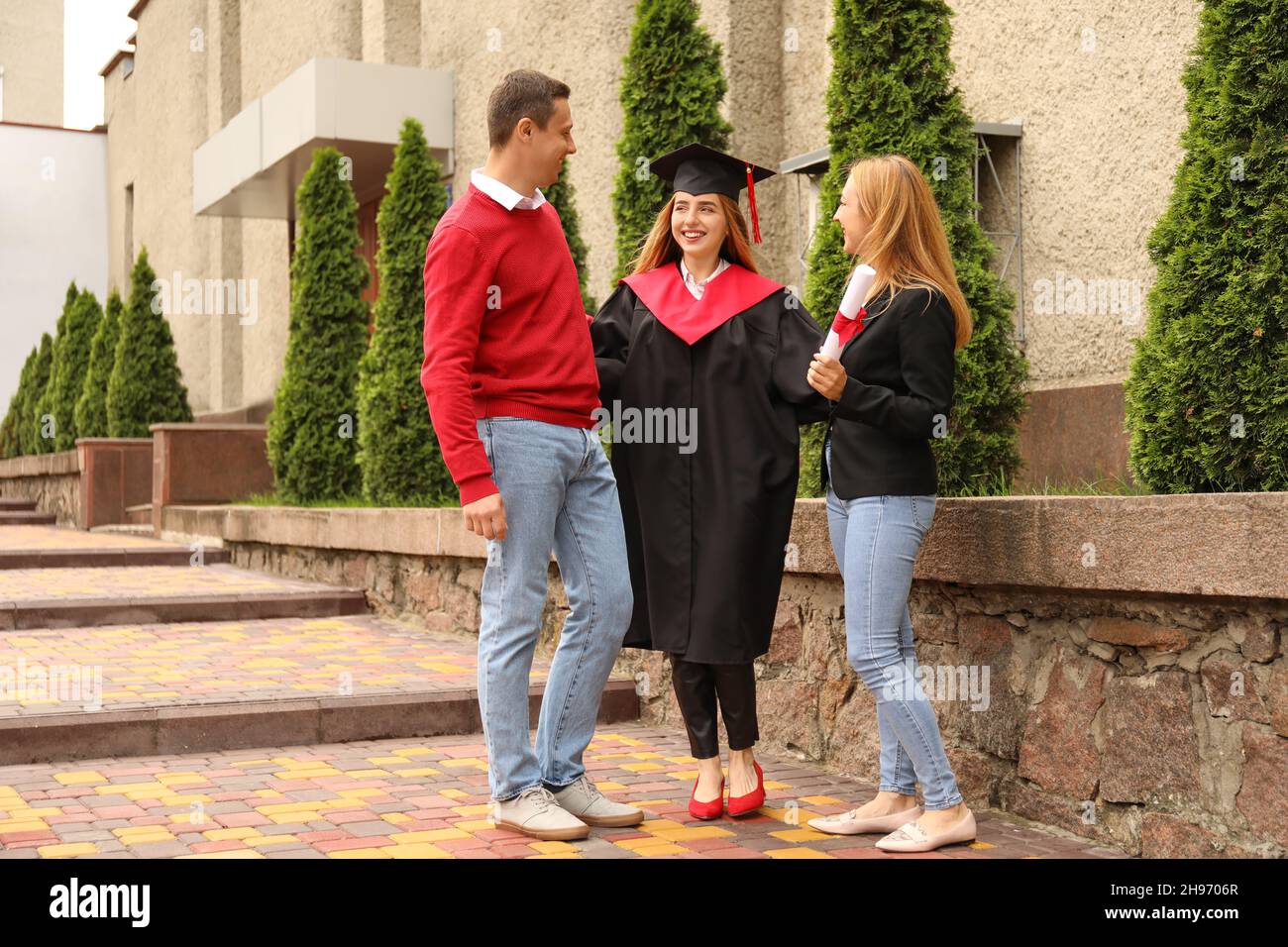 Happy young woman with her parents on graduation day Stock Photo - Alamy