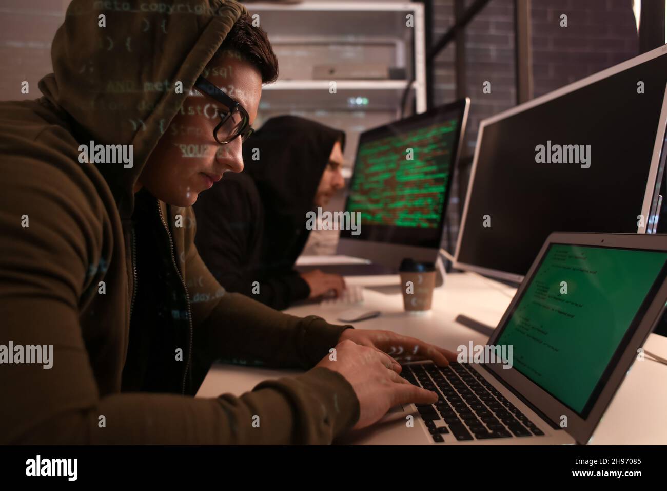 Hackers using computers in dark room Stock Photo - Alamy