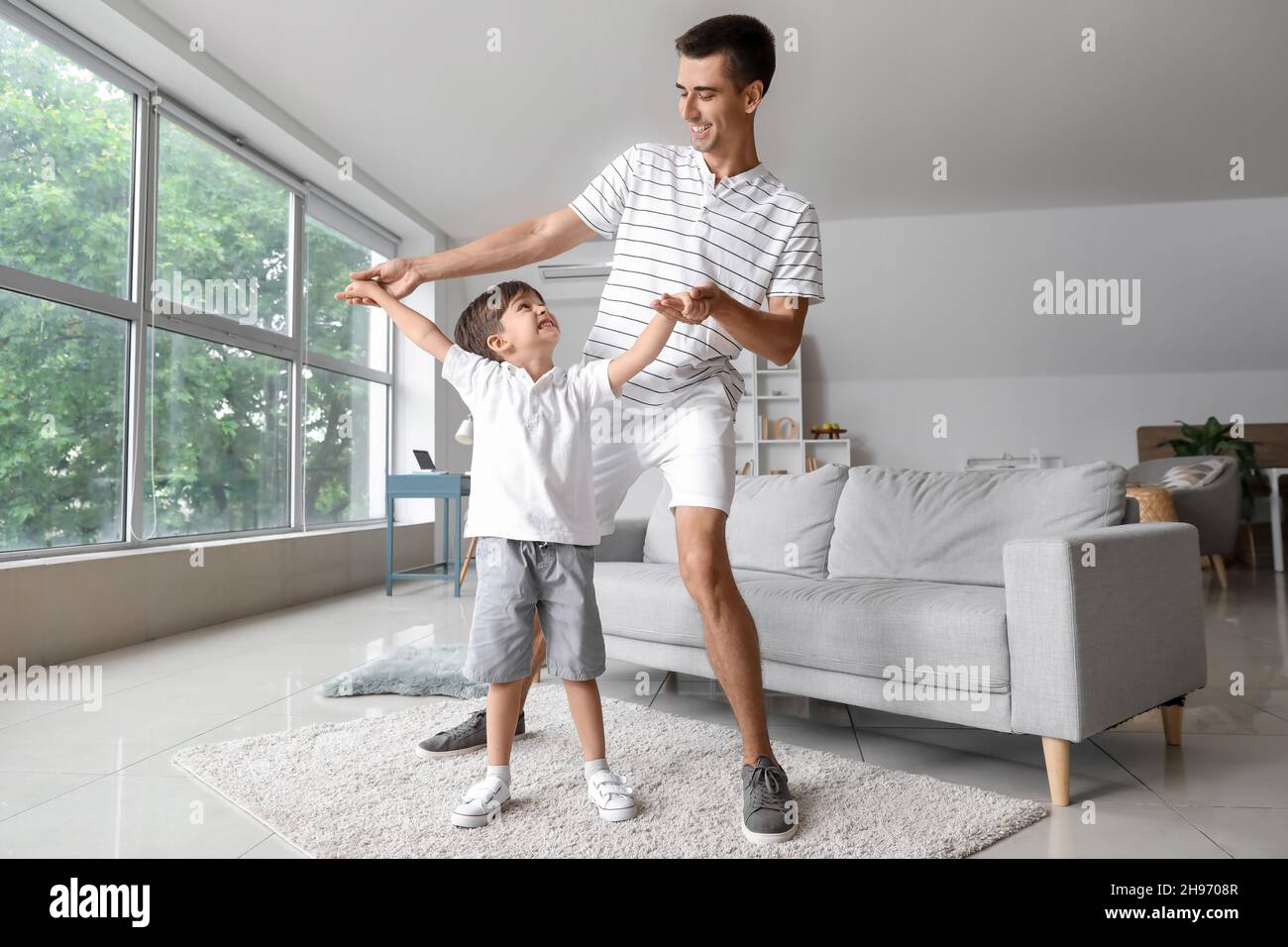 Man and his little son dancing at home Stock Photo - Alamy