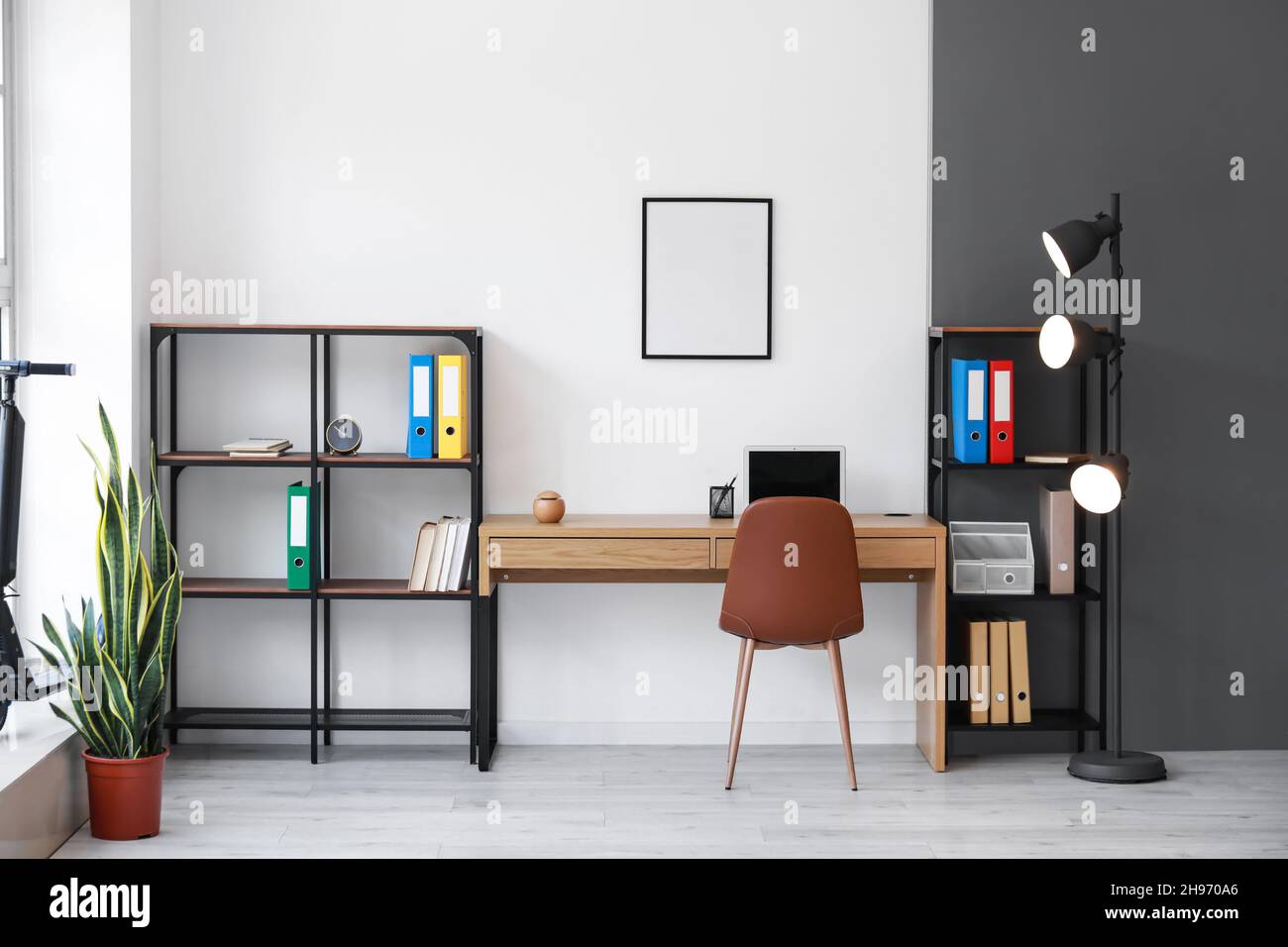 Interior of light office with workplace, shelving units and glowing ...