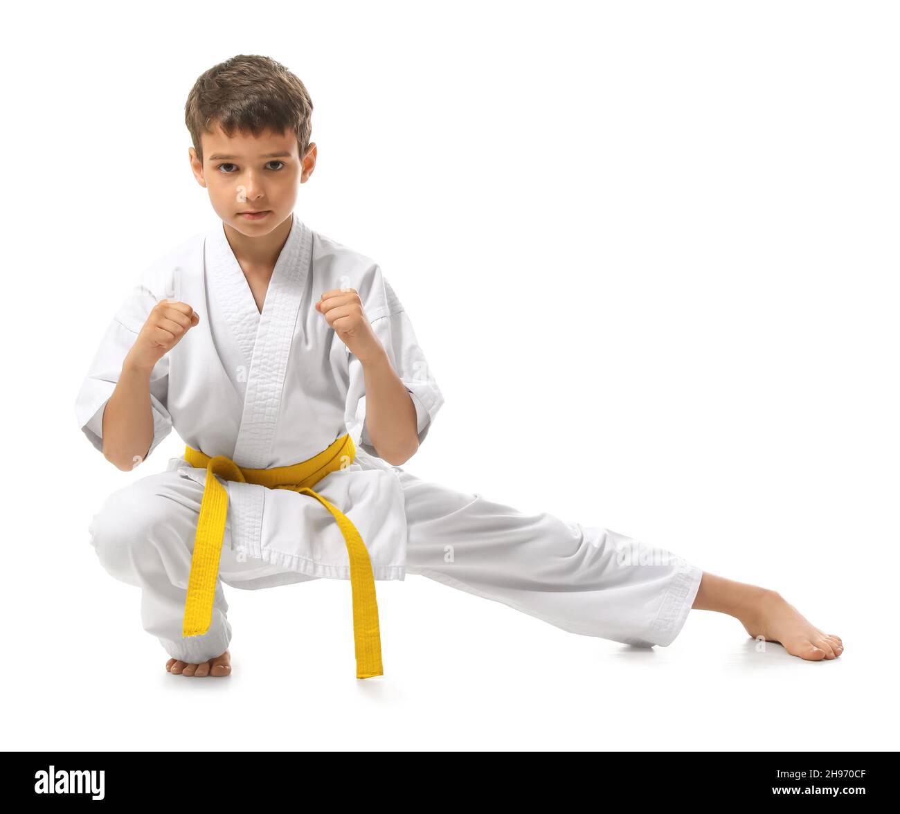 Little boy practicing karate on white background Stock Photo - Alamy