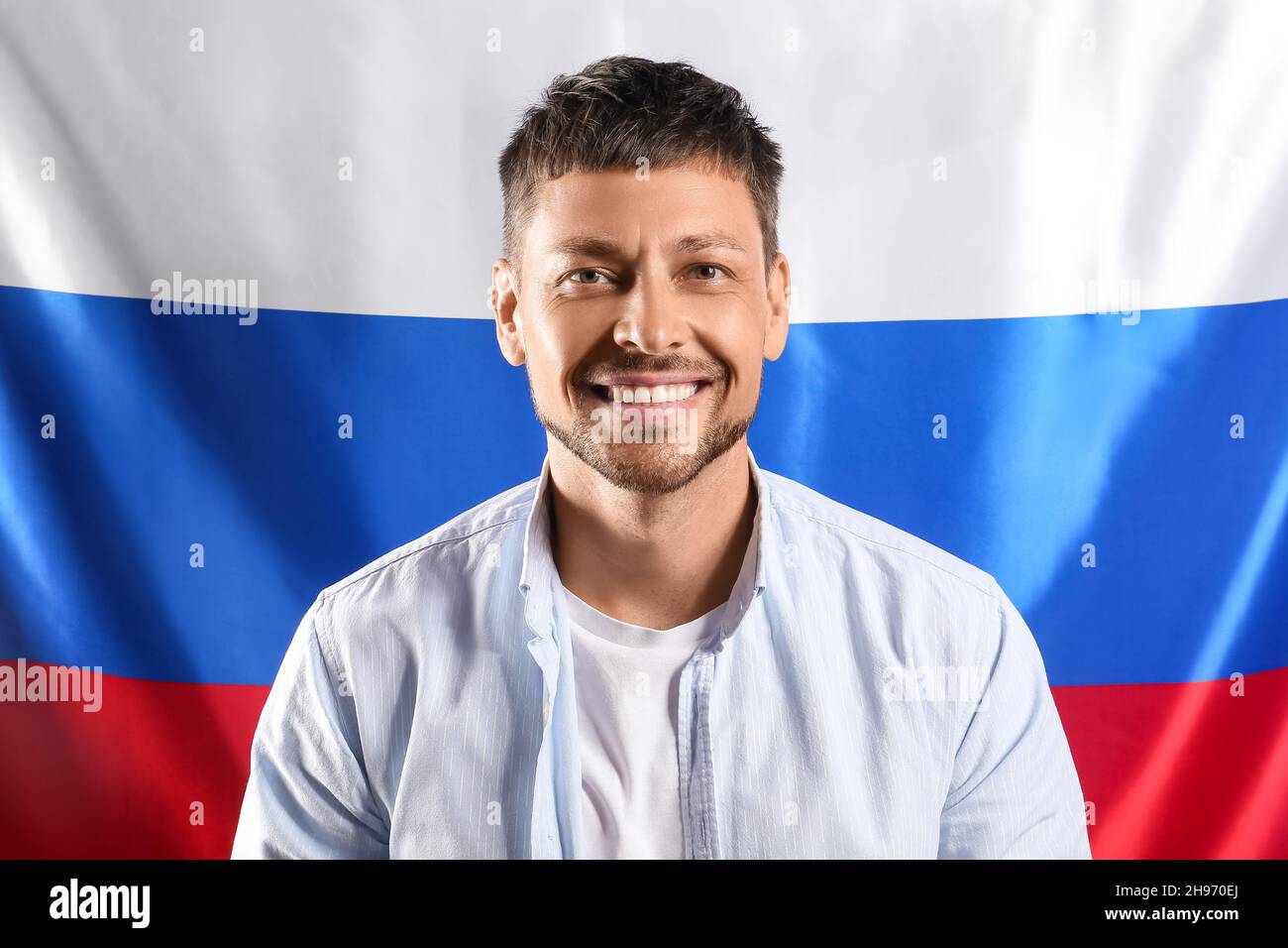 Handsome man against flag of Russia Stock Photo - Alamy
