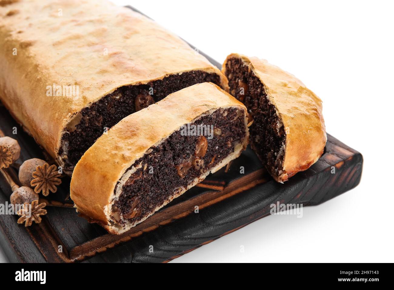 Wooden board with tasty poppy seed strudel on white background, closeup ...