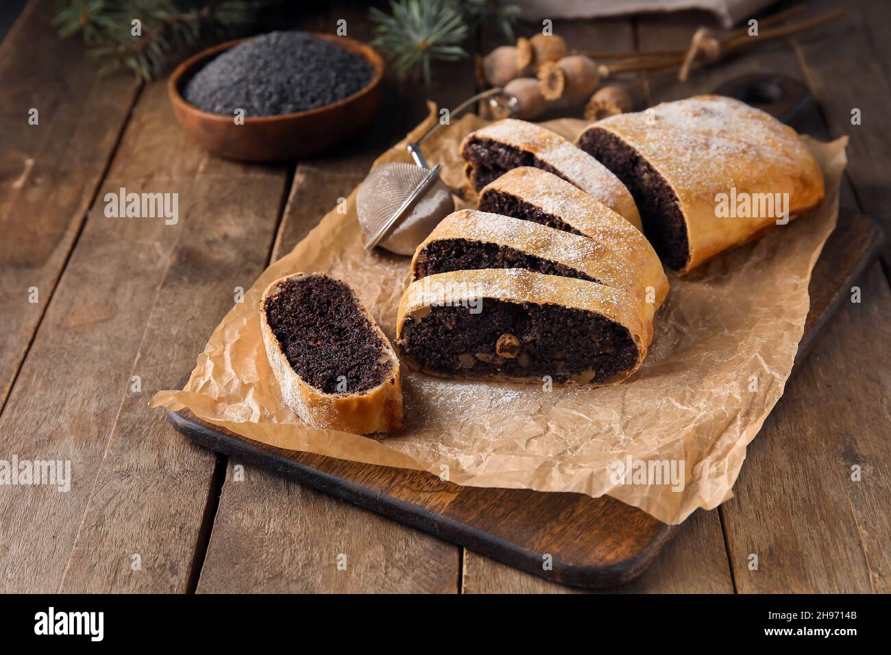 Board with tasty poppy seed strudel on wooden background Stock Photo ...