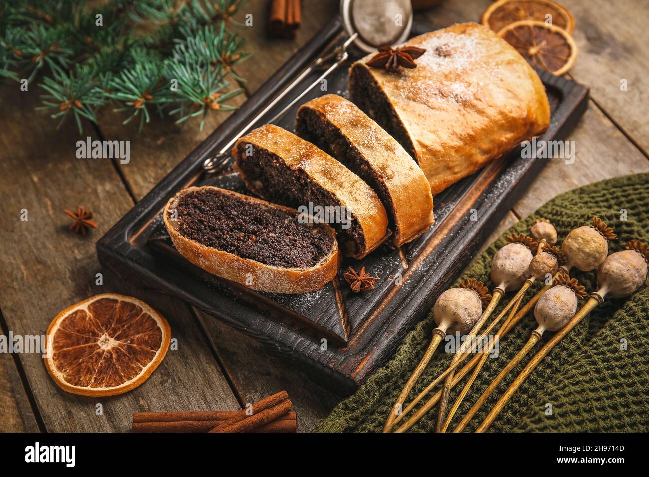 Board with tasty poppy seed strudel on wooden background Stock Photo ...
