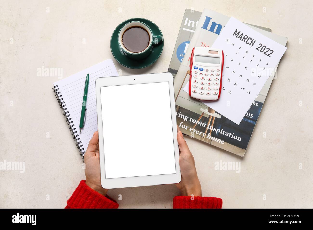 Female hands with tablet computer, paper calendar for March 2022 ...