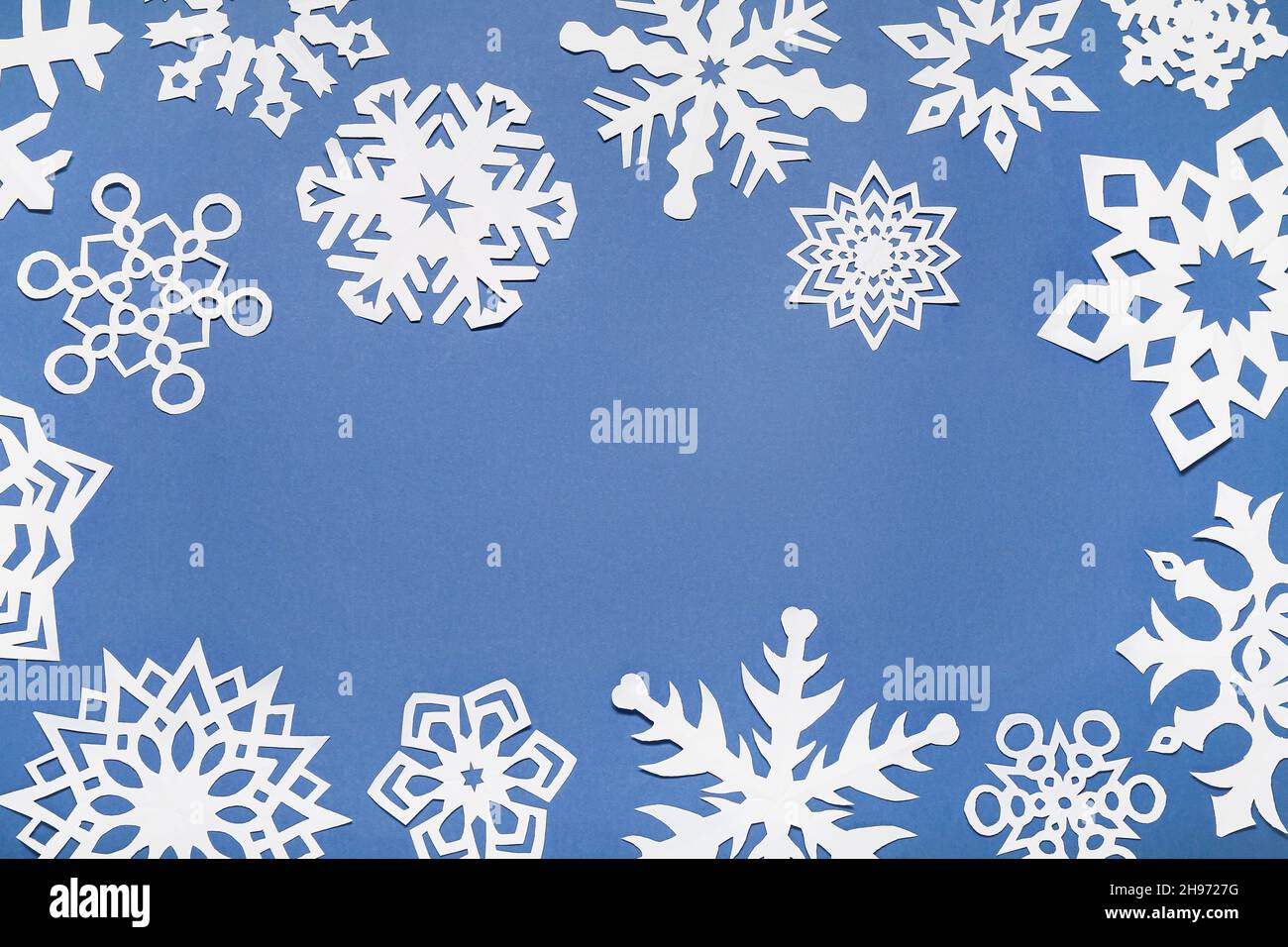 Frame made of beautiful paper snowflakes on blue background Stock Photo ...
