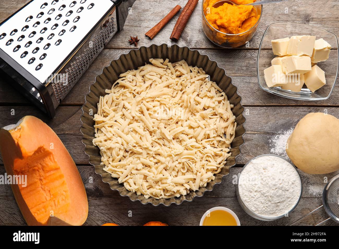 Baking dish with uncooked pumpkin pie and ingredients on wooden ...