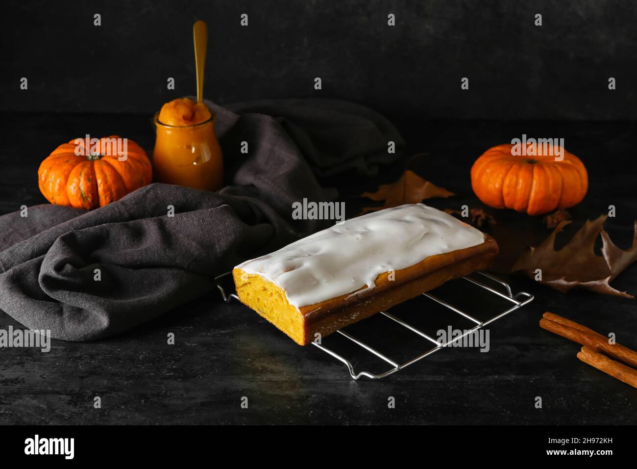 Grid with fresh pumpkin pie on black background Stock Photo - Alamy
