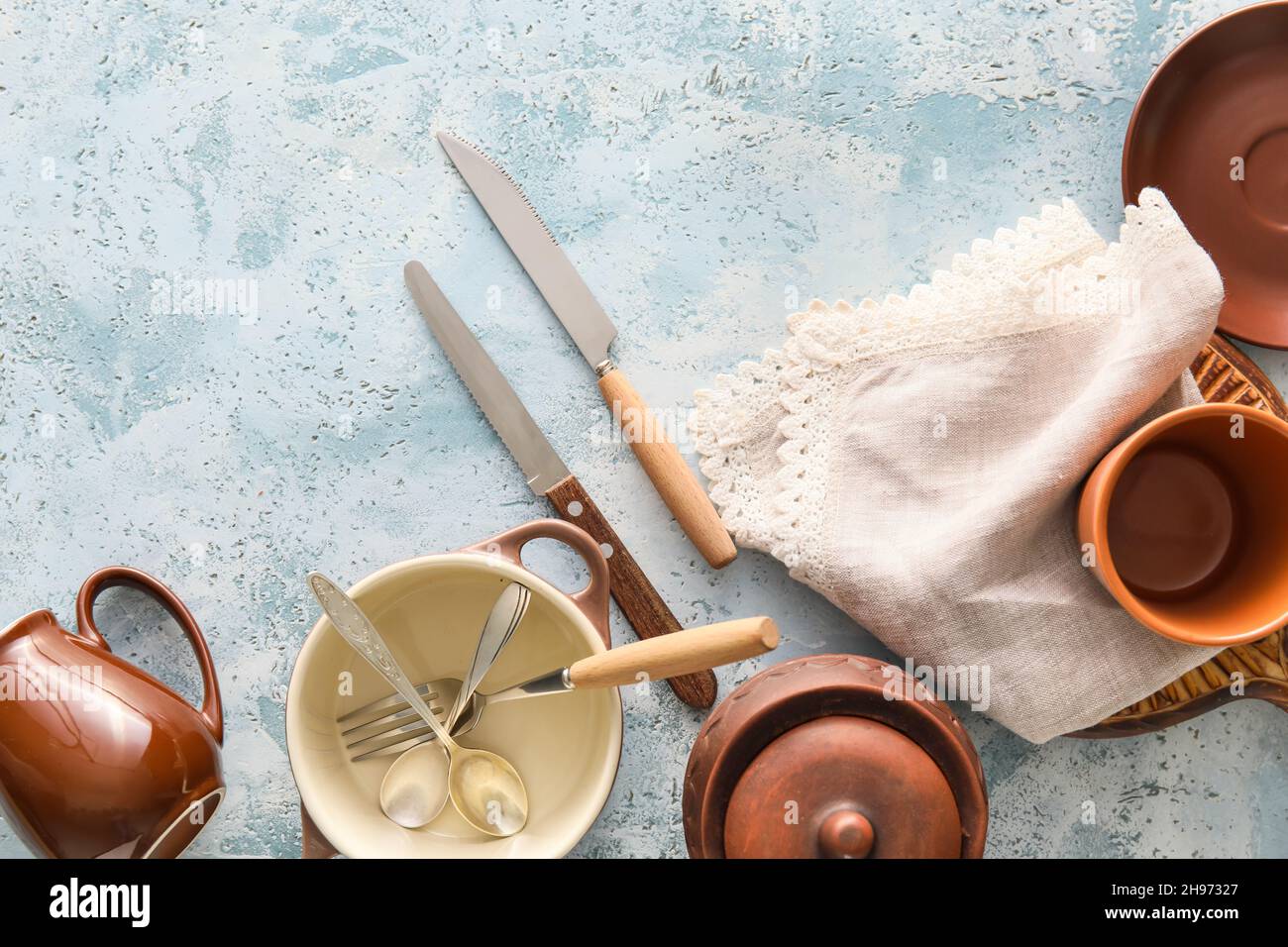 Set of stylish dinnerware on blue grunge background Stock Photo - Alamy