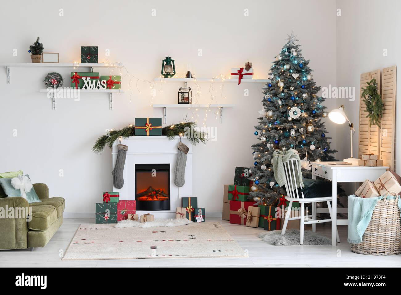 Interior of festive living room with modern workplace, Christmas tree ...