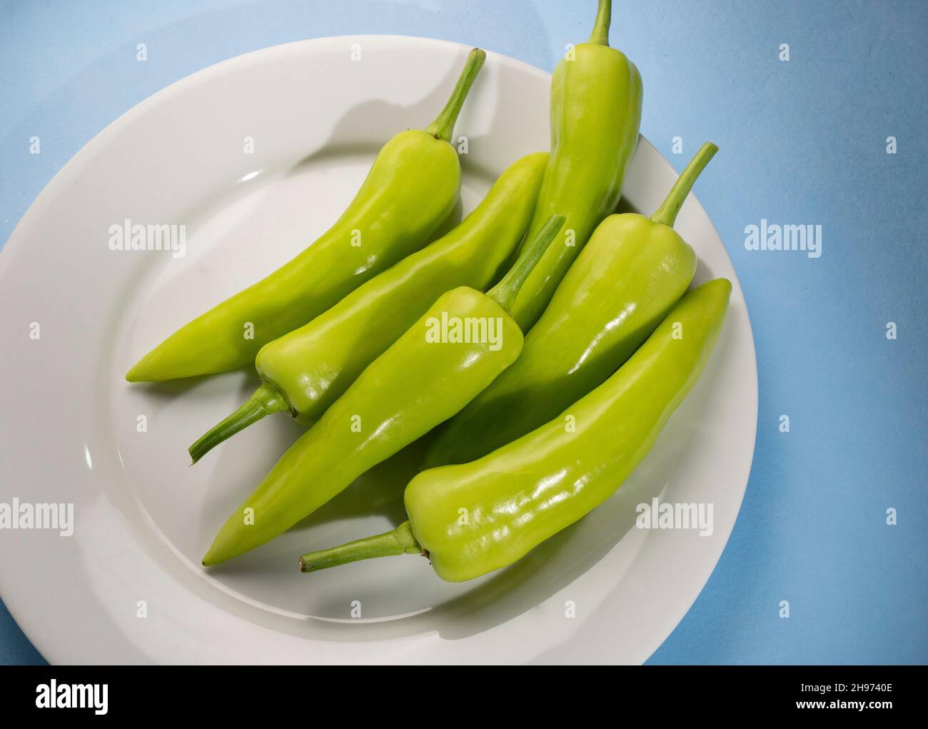 Close up of frsh green chilli peppers on tabel Stock Photo - Alamy