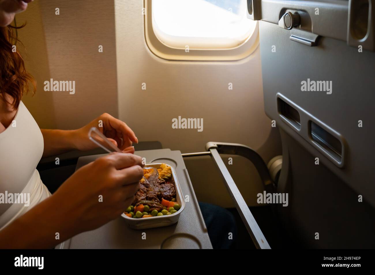Flight attendant serving dinner on hi-res stock photography and images ...
