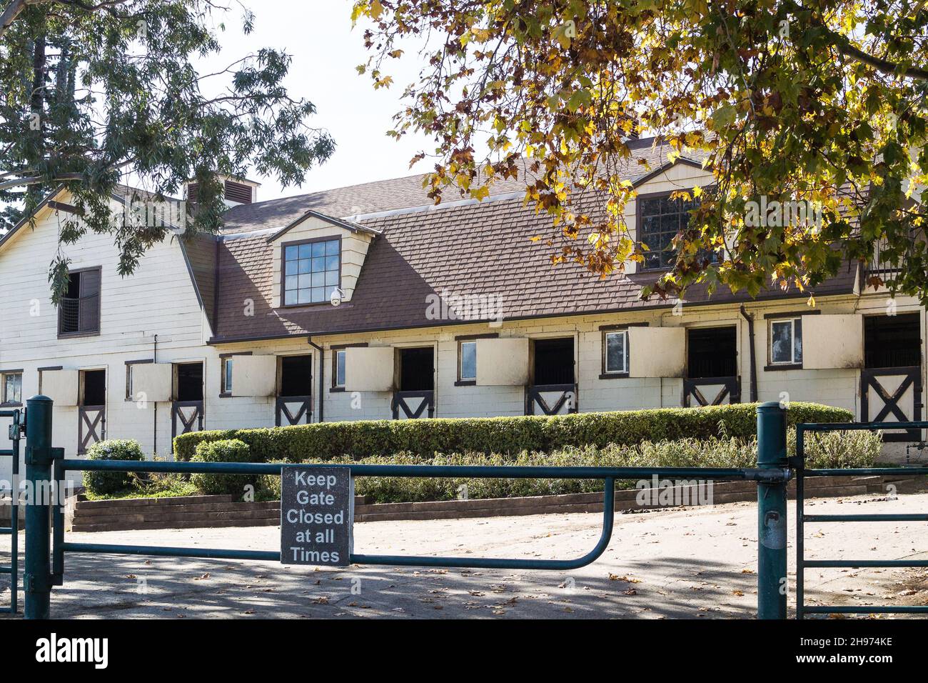 Riding stables for horses at Byrne Preserve with stable doors open and ...