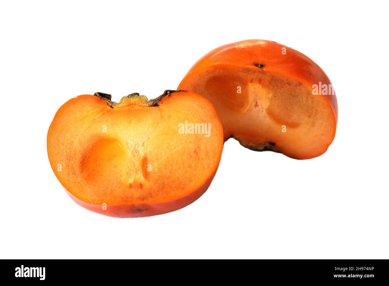 Ripe persimmons are cut in half separately placed on a white background ...