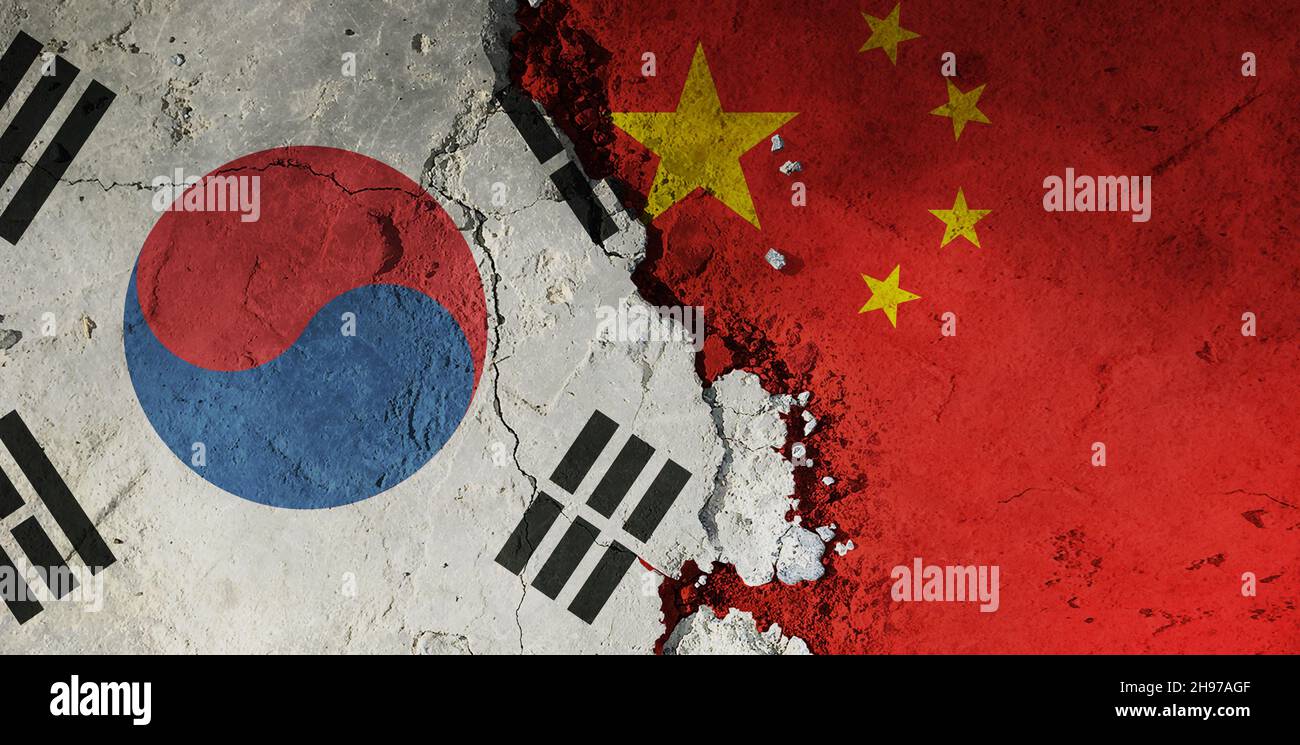 South Korea vs China flag on a rough background. Broken and cracked ...