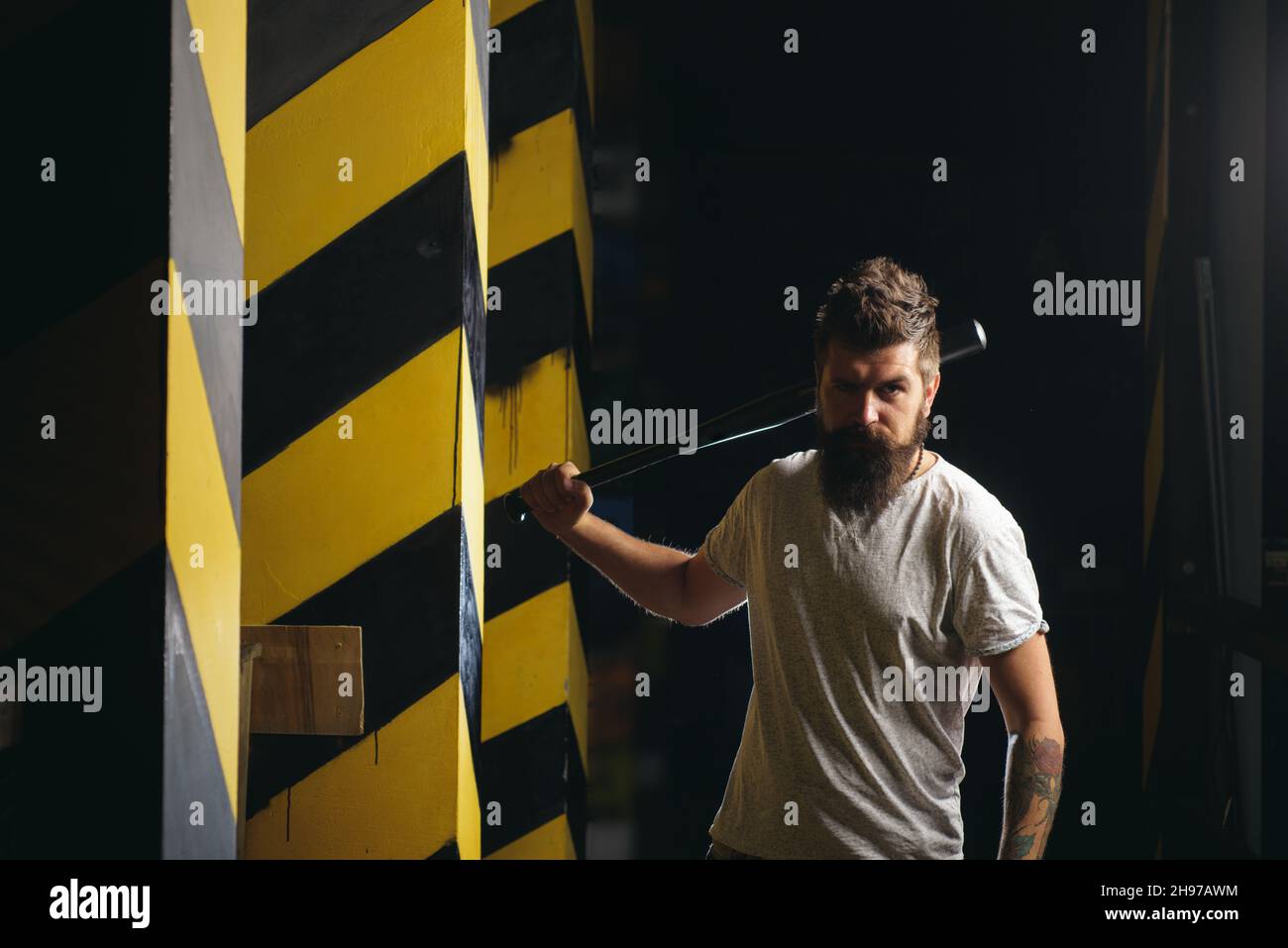 Confident attractive man with serious face holding baseball bat Stock ...