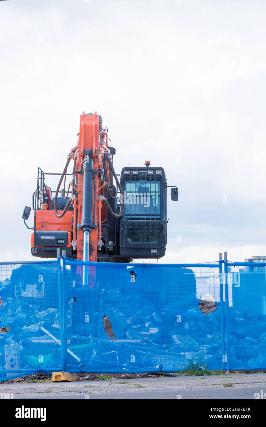 A front on image of an excavator on a construction site, behind a ...