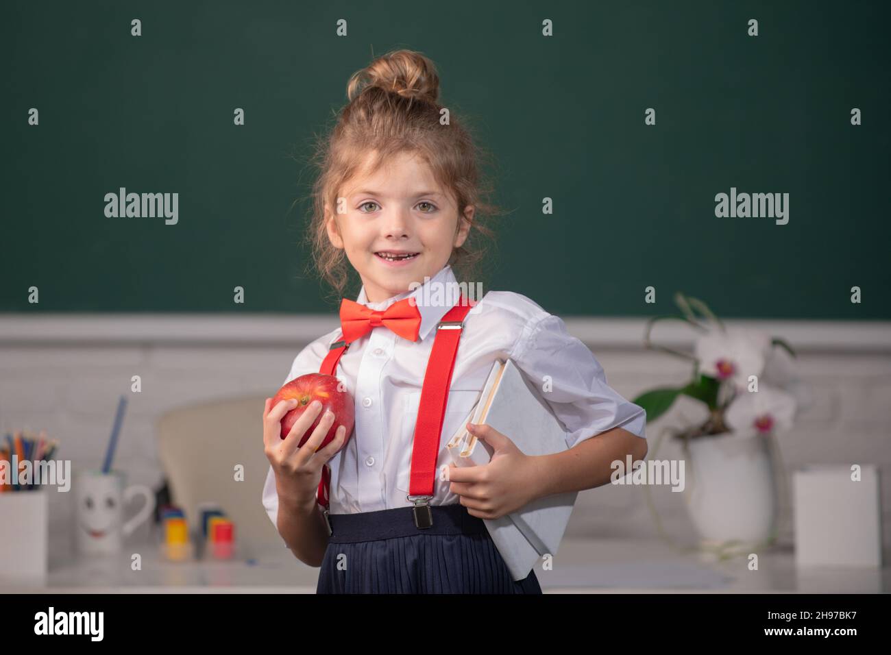 Cute little child studying in classroom at elementary school. Education ...