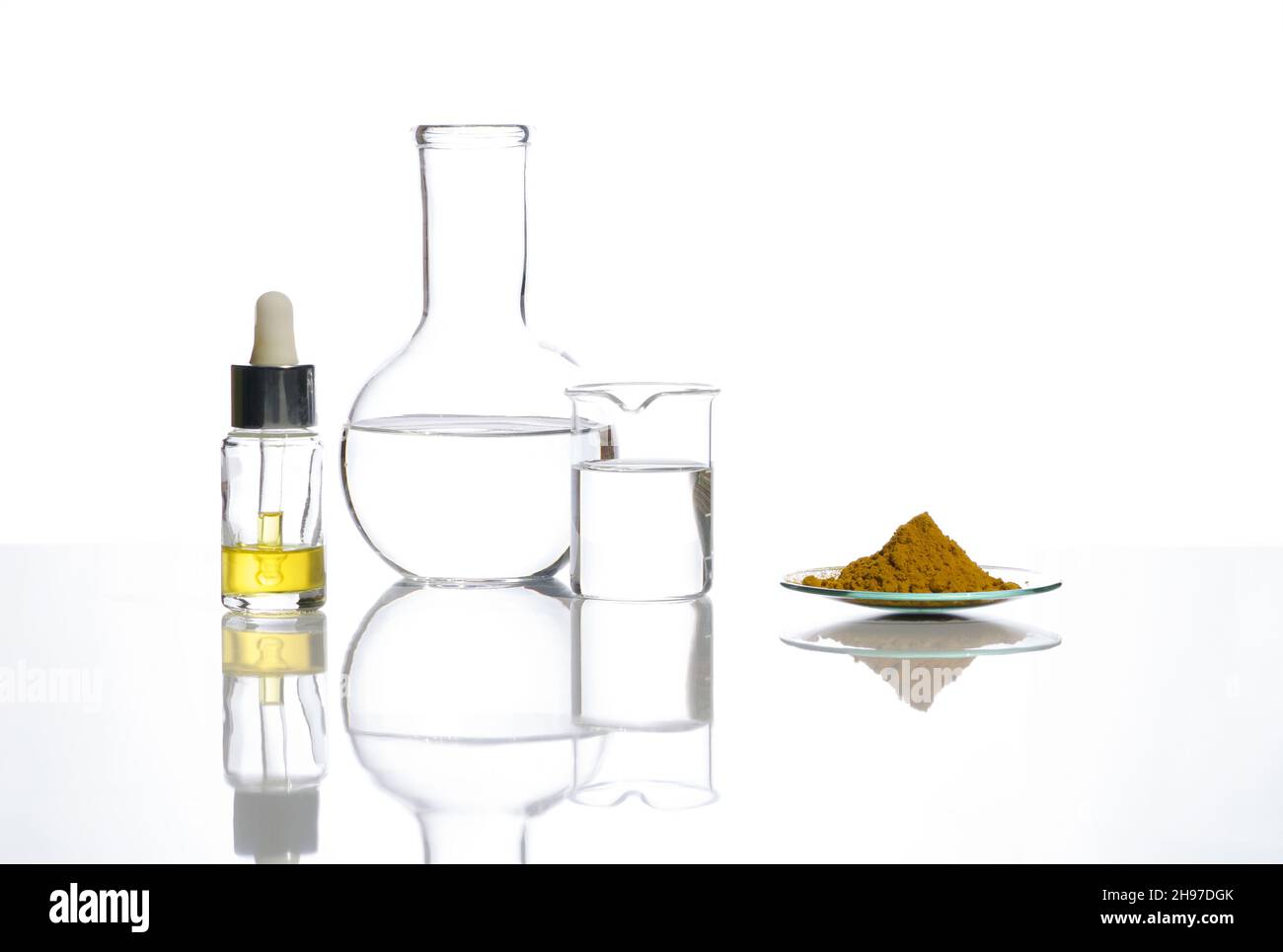 Closeup chemical ingredient on white laboratory table. Yellow cosmetic ...