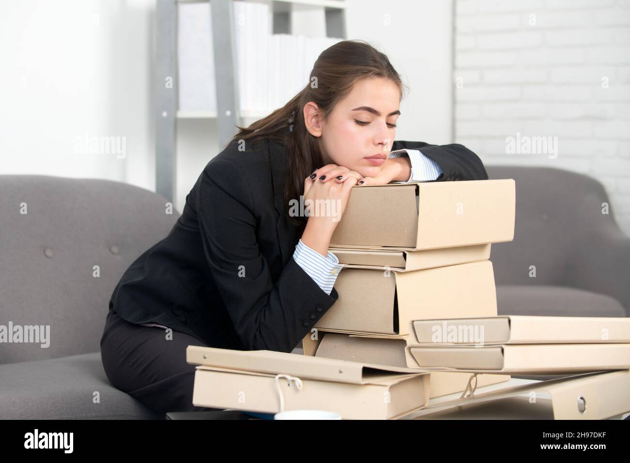 Sad busy secretary, stressed overworked business woman and folders with ...