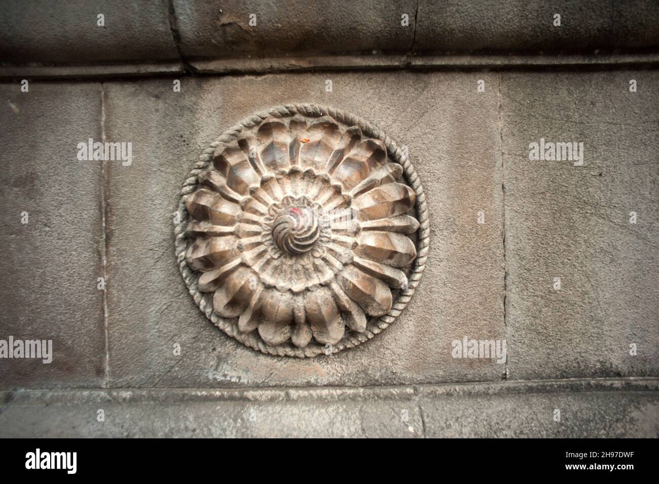 Circular design carved in a stone on temples wall Stock Photo - Alamy