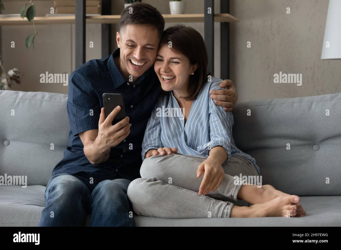 Happy cheerful married couple talking on video call on smartphone Stock ...