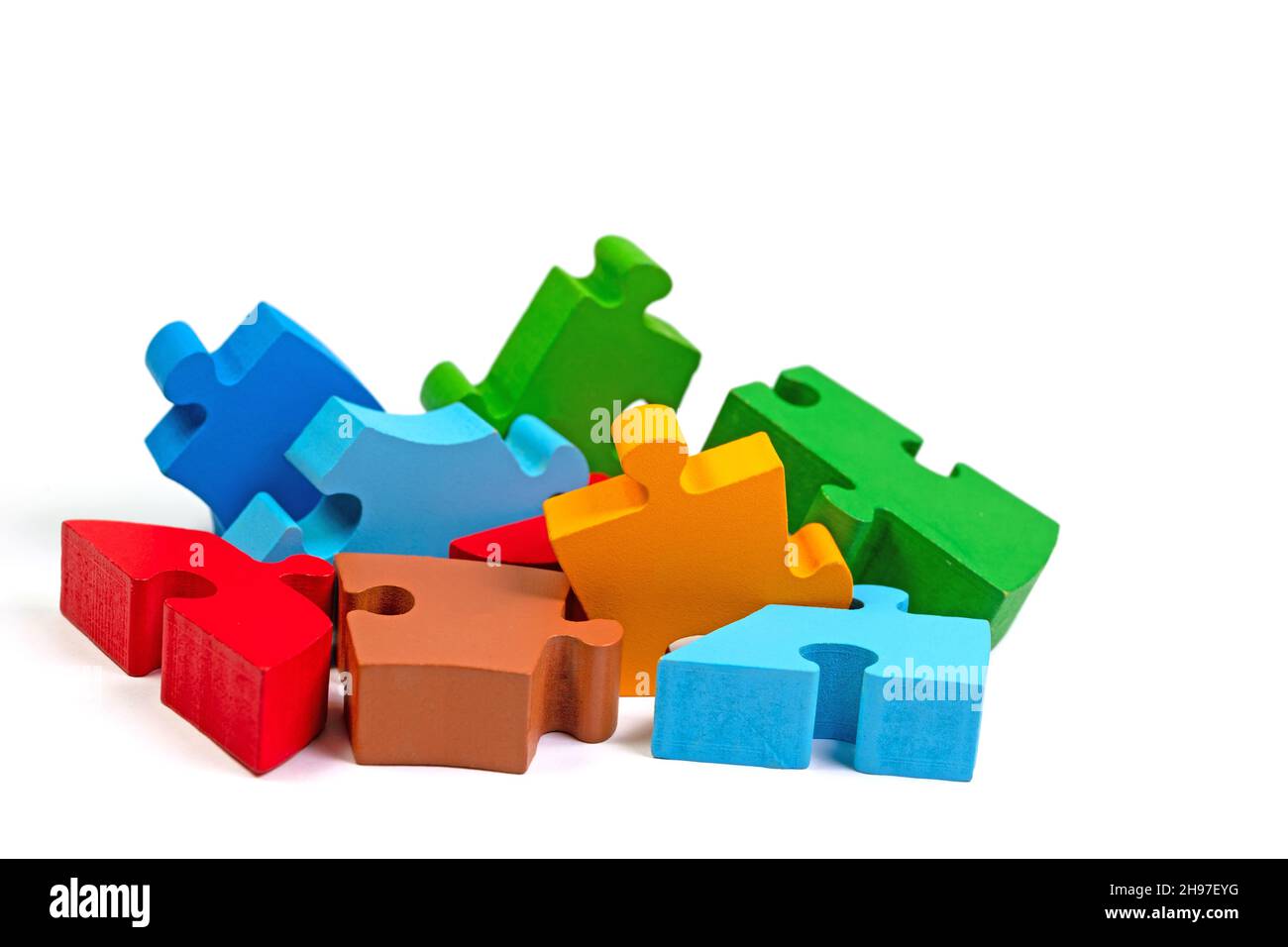 Colorful wooden puzzle pieces against white background Stock Photo - Alamy