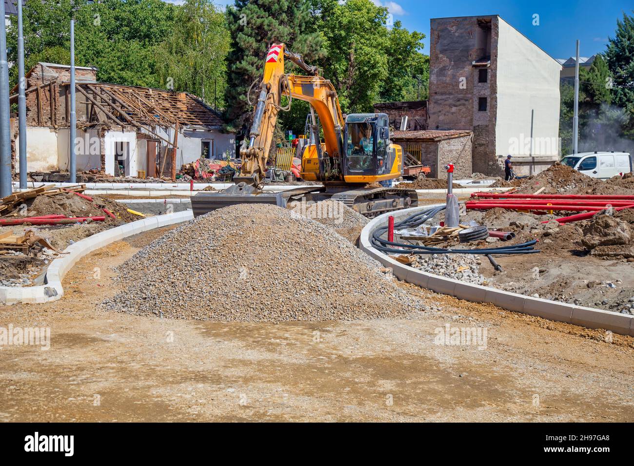 New road roundabout under construction with excavator Stock Photo - Alamy