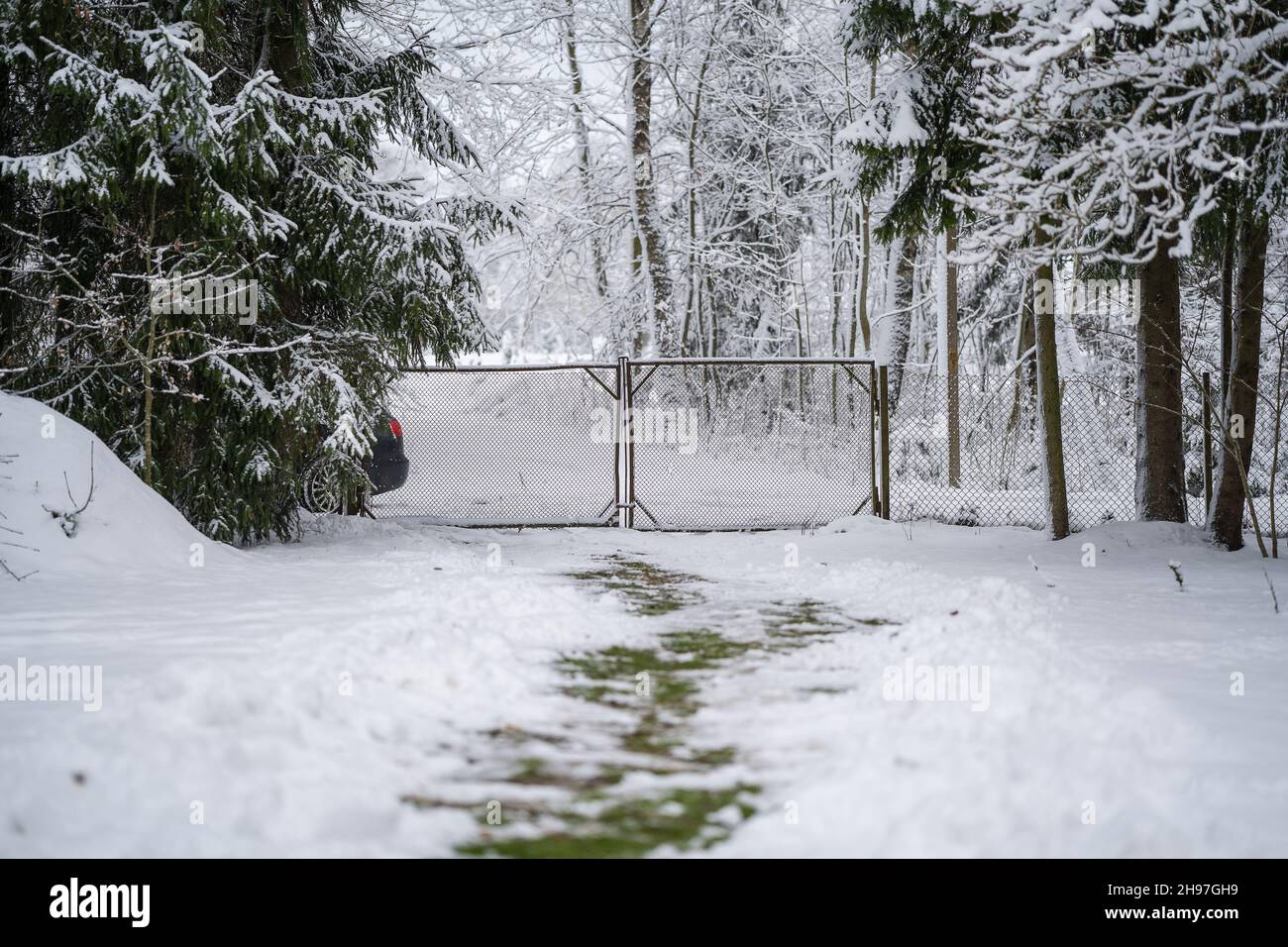 The cleared path from snow to closed gates Stock Photo - Alamy