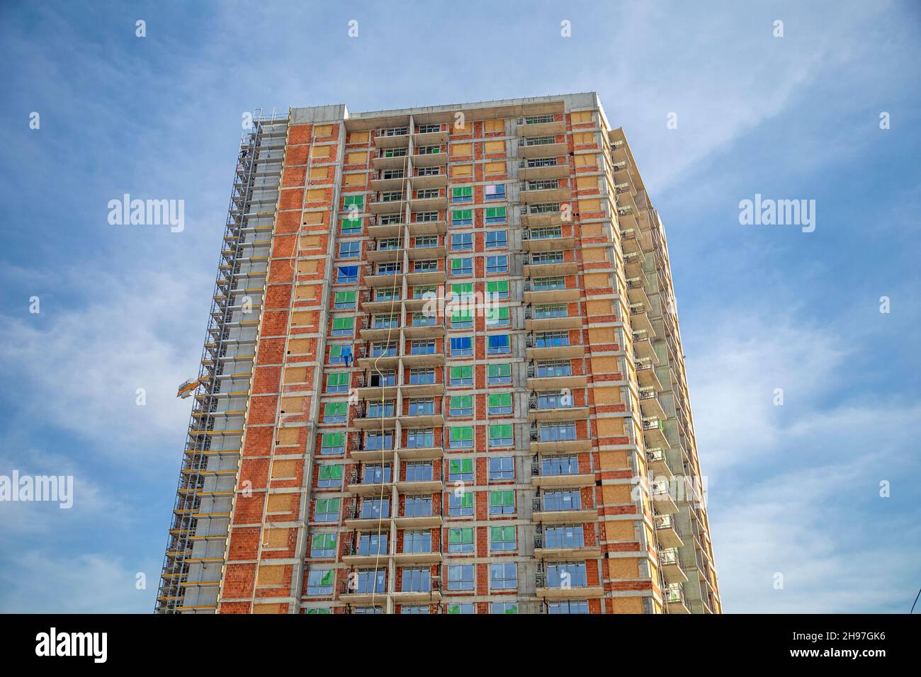 Unfinished building construction with scaffolding detail on ...