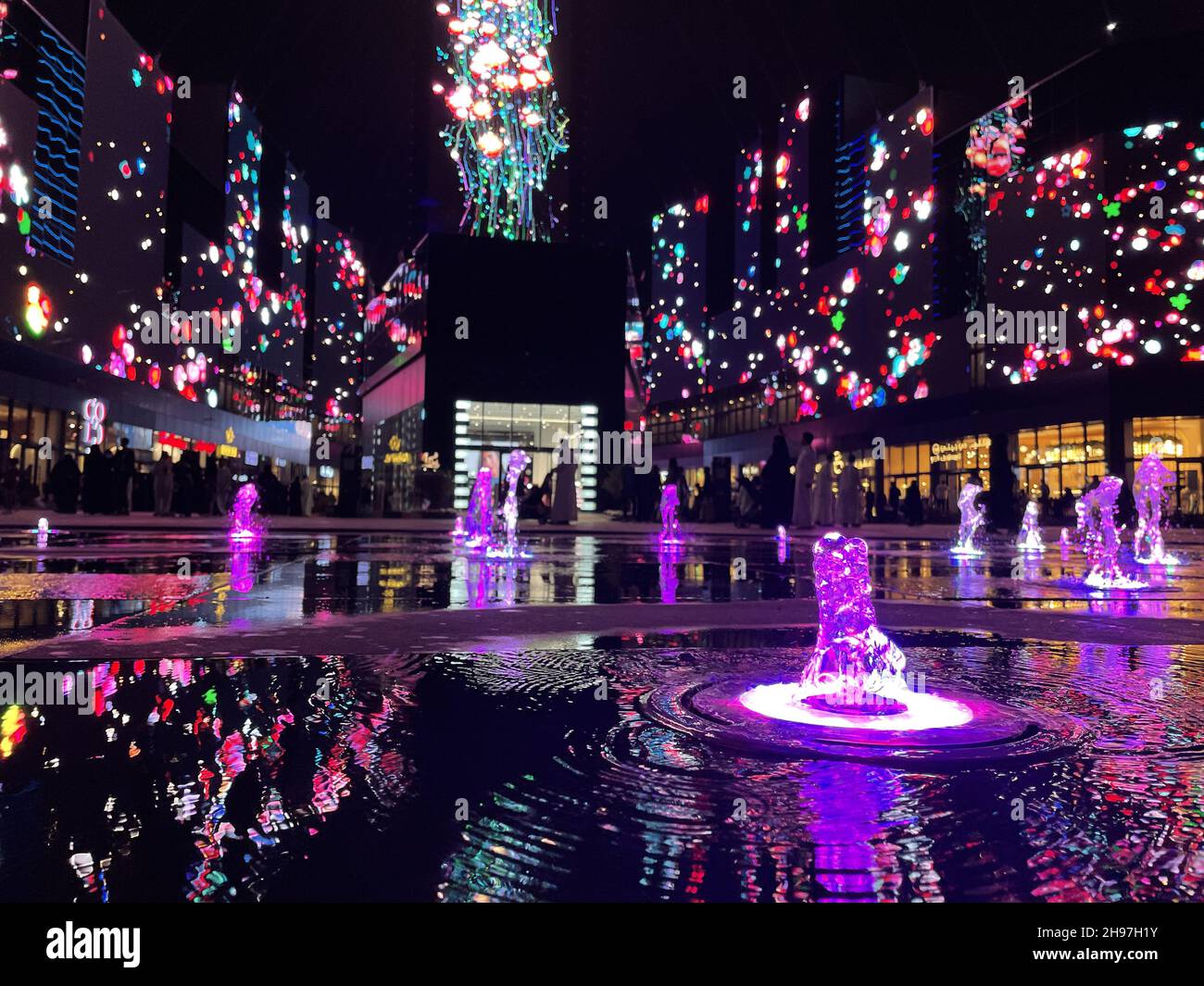 Reflection of colors on water fountains and screens that display ...