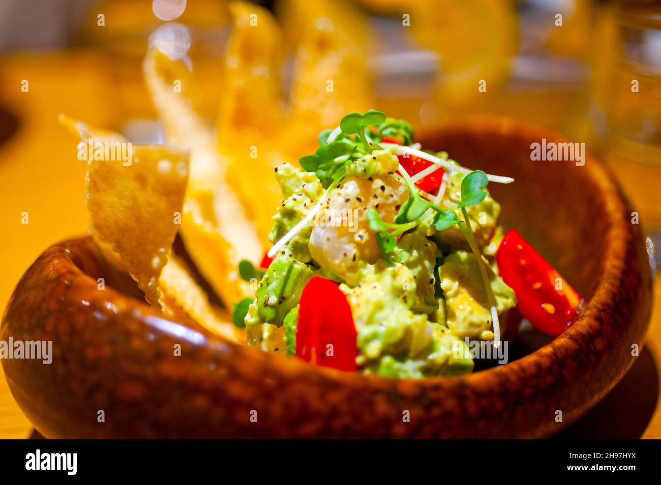 fresh avocado and shrimps salad with nachos on side Stock Photo - Alamy