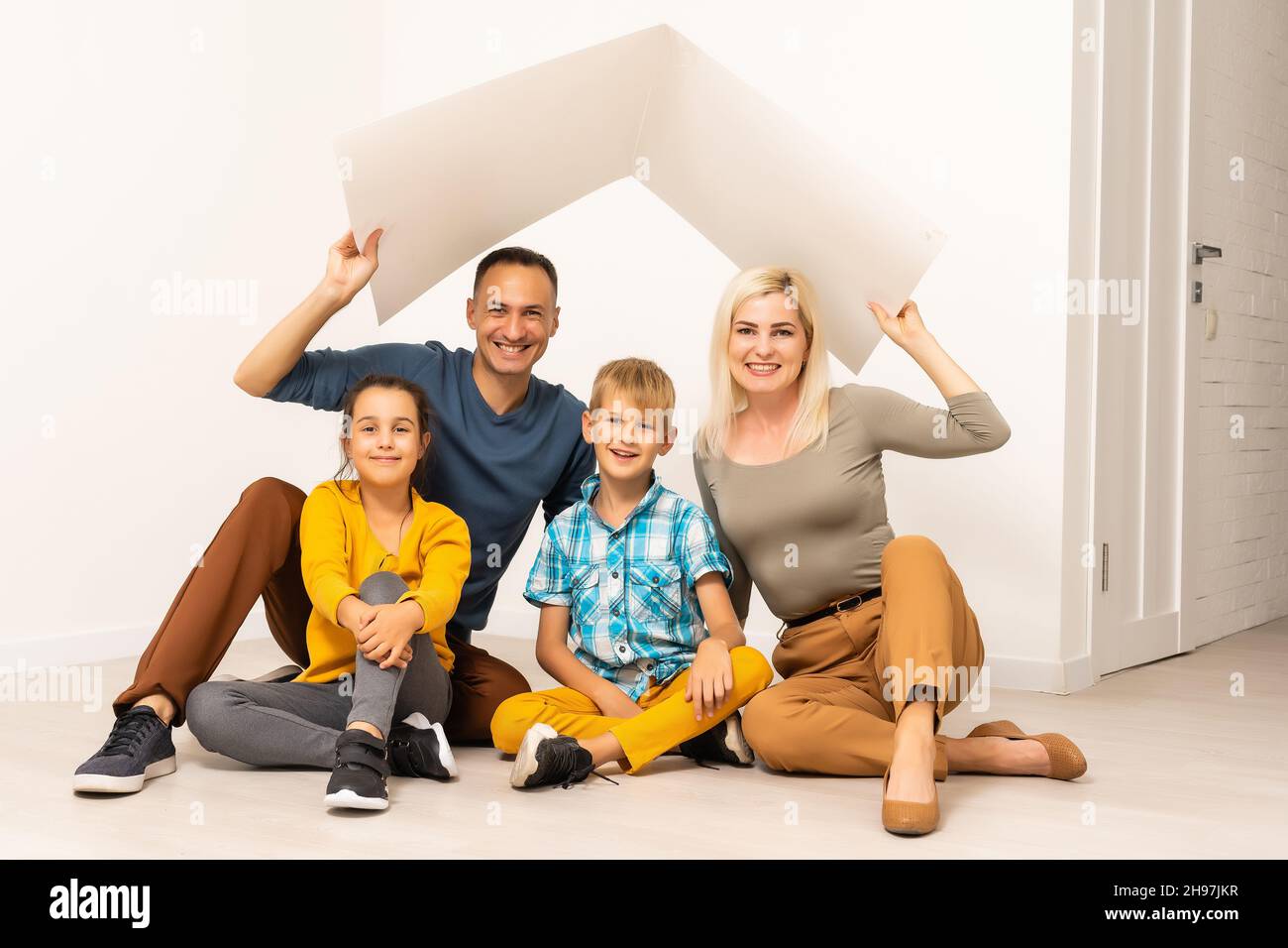 Happy family in a safe home - isolated over white background Stock ...