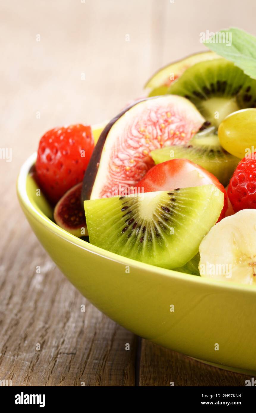 Healthy fruit mix salad on the kitchen table Stock Photo - Alamy